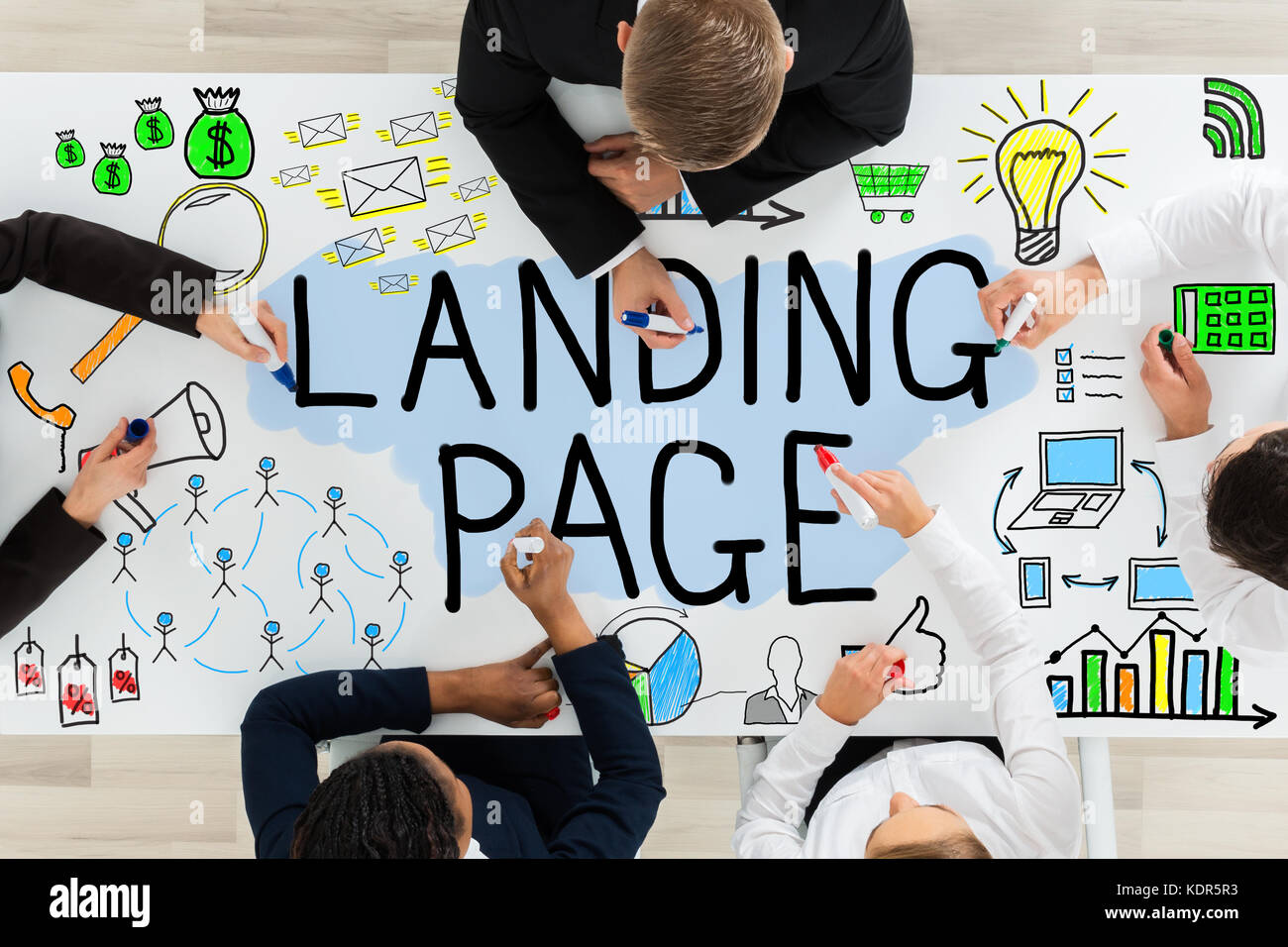 High Angle View Of Businesspeople Drawing Landing Page Concept On ...