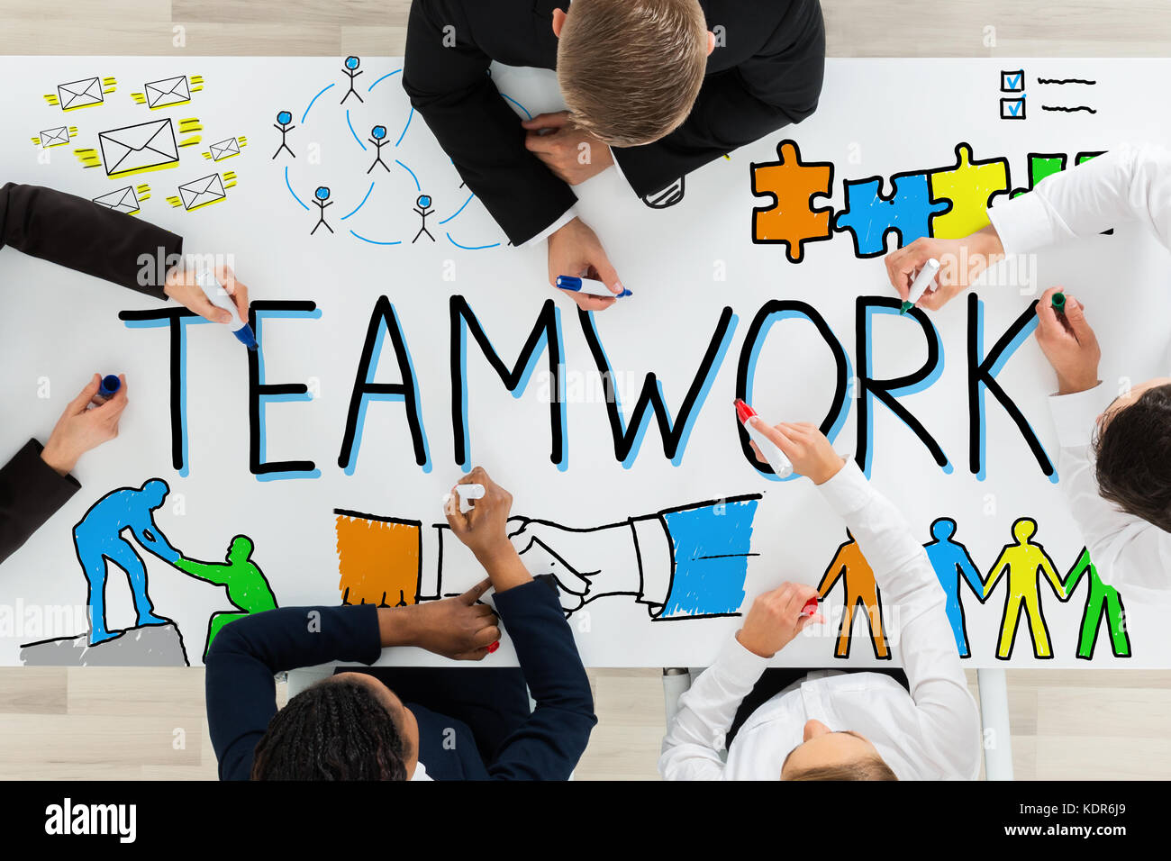 High Angle View Of Businesspeople Drawing Teamwork Concept On Office ...