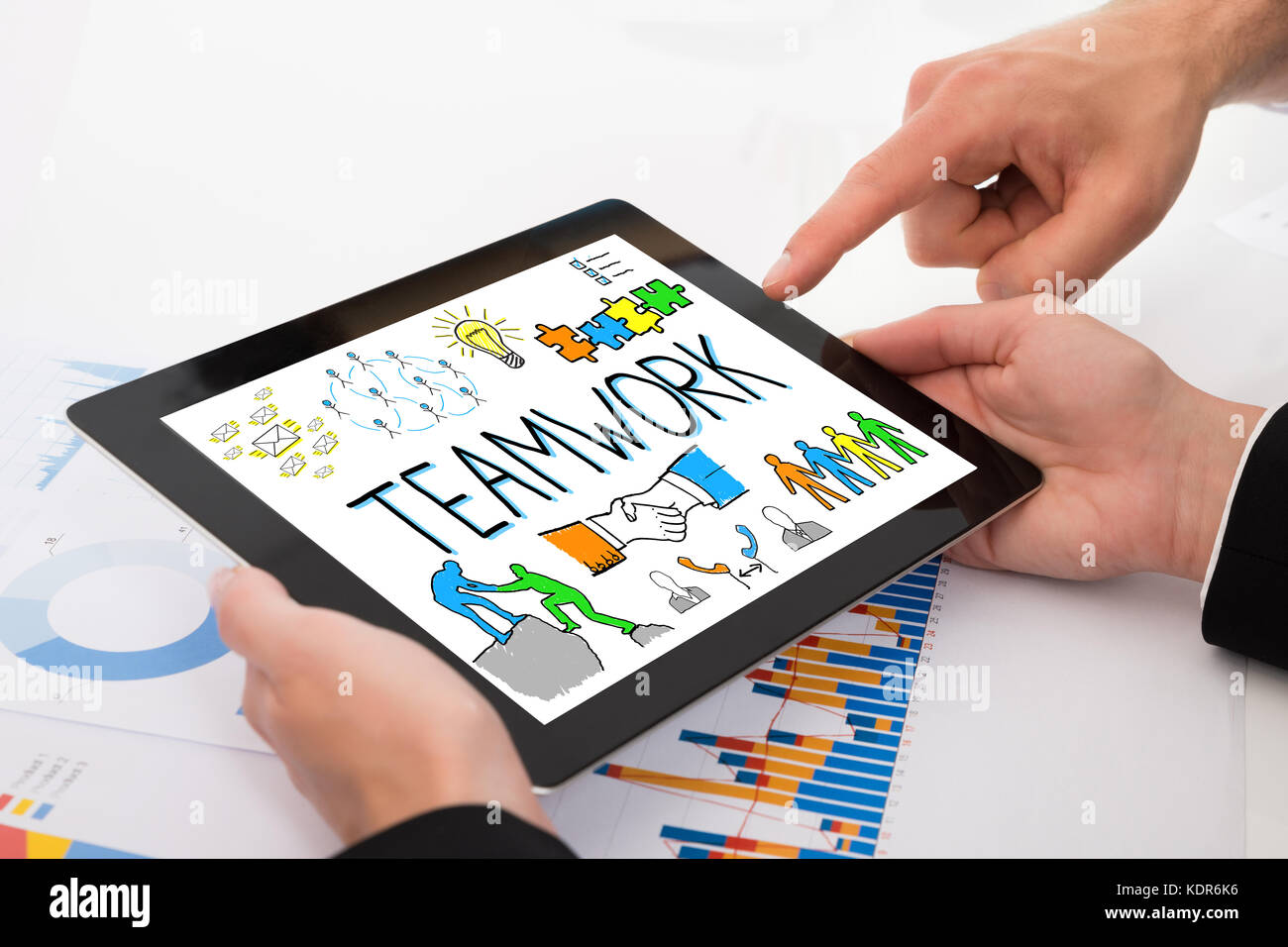 Two Businesspeople Discussing Teamwork On Digital Tablet At Office Desk ...