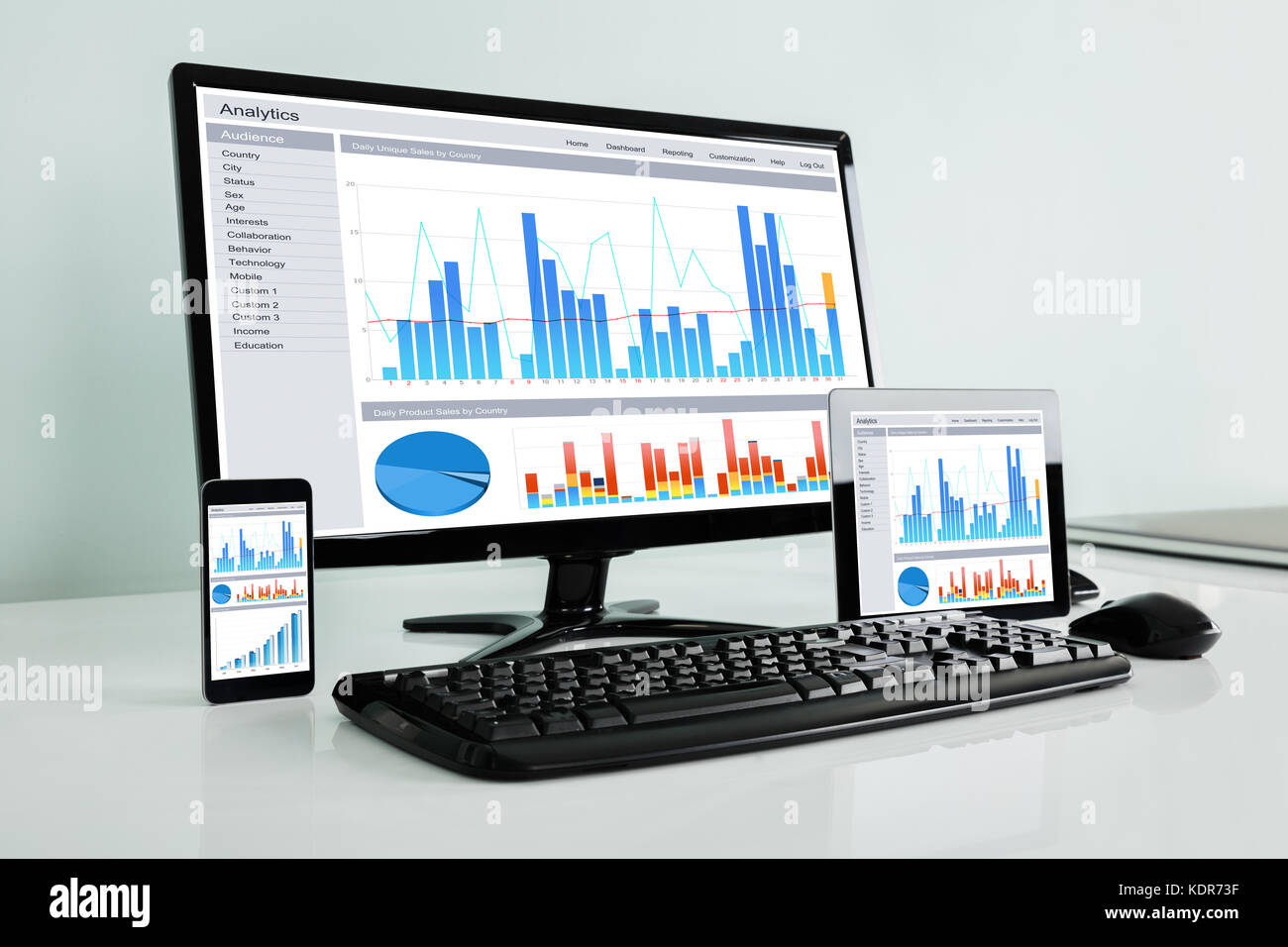 Close-up Of Different Electronic Gadget Showing Graph On Office Desk ...
