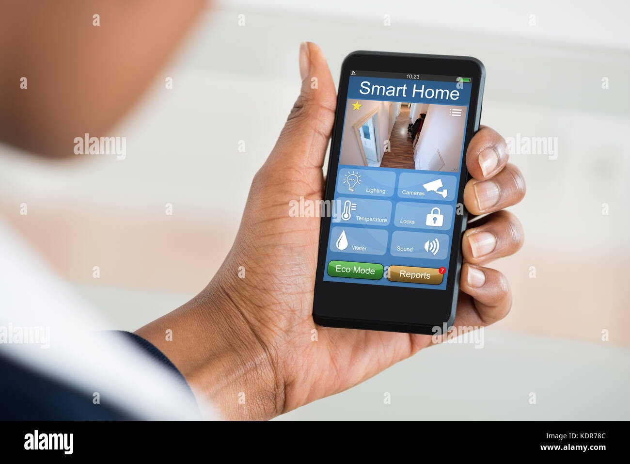 Close-up Of Person Using Smart Home System On Mobilephone At White Desk ...