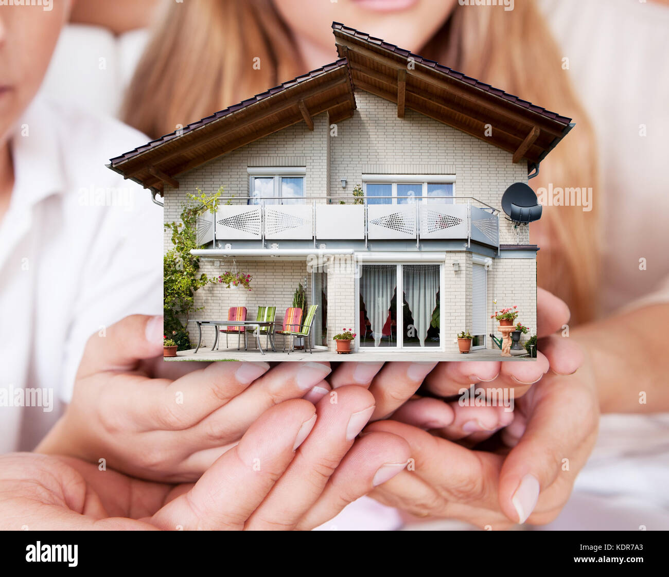 Close-up Of Family Holding The House Model Together Stock Photo - Alamy