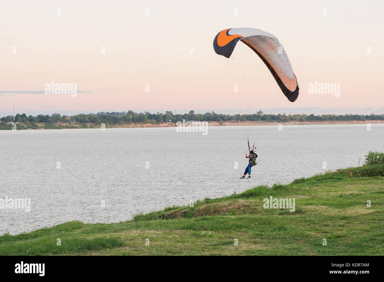 young woman parachuting down to the ground Riverside Stock Photo - Alamy