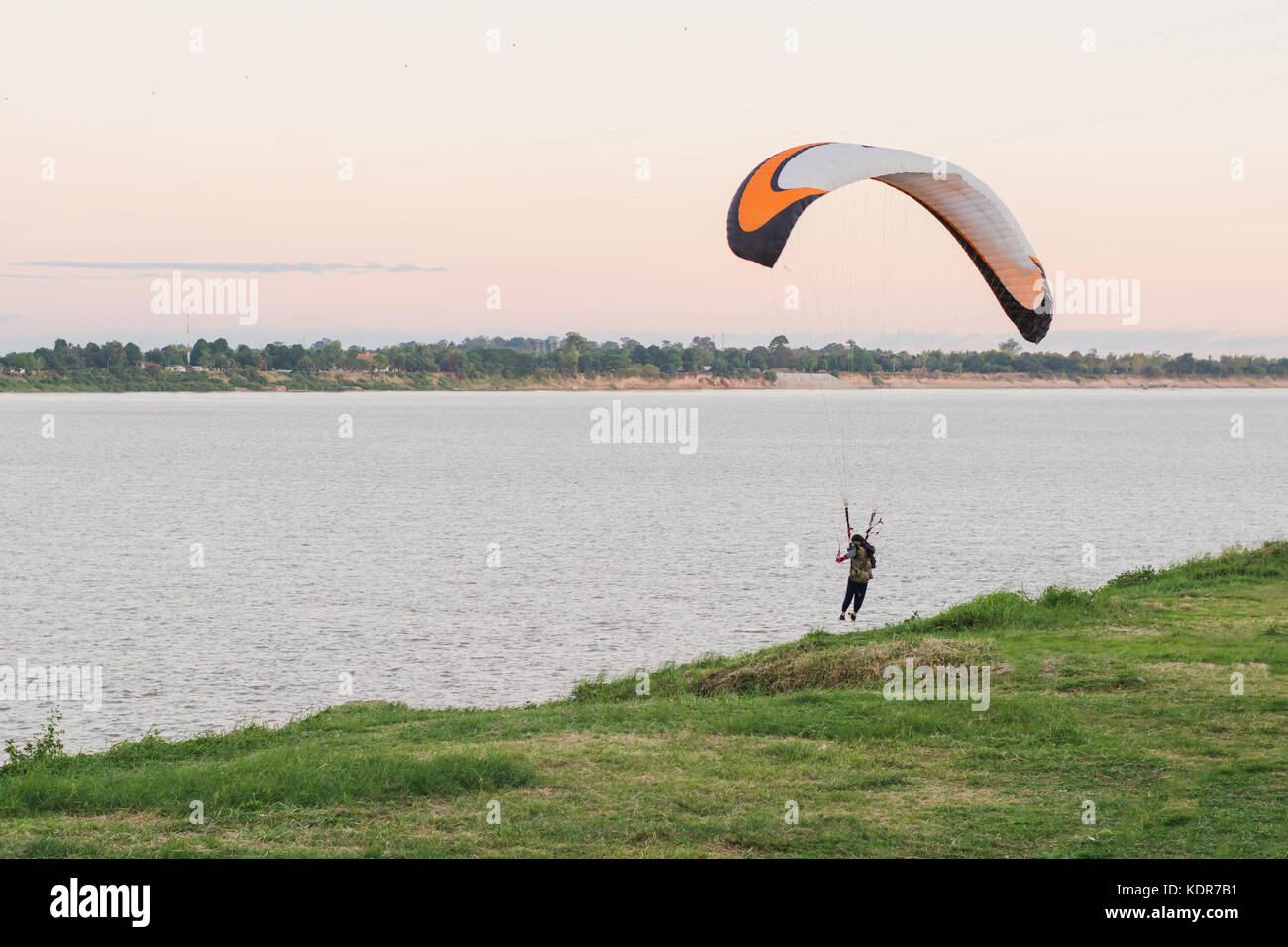 young woman parachuting down to the ground Riverside Stock Photo - Alamy