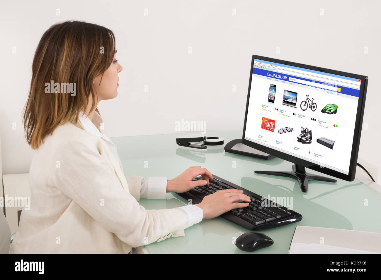 Businesswoman Shopping Online On Computer Desktop At Office Desk Stock ...
