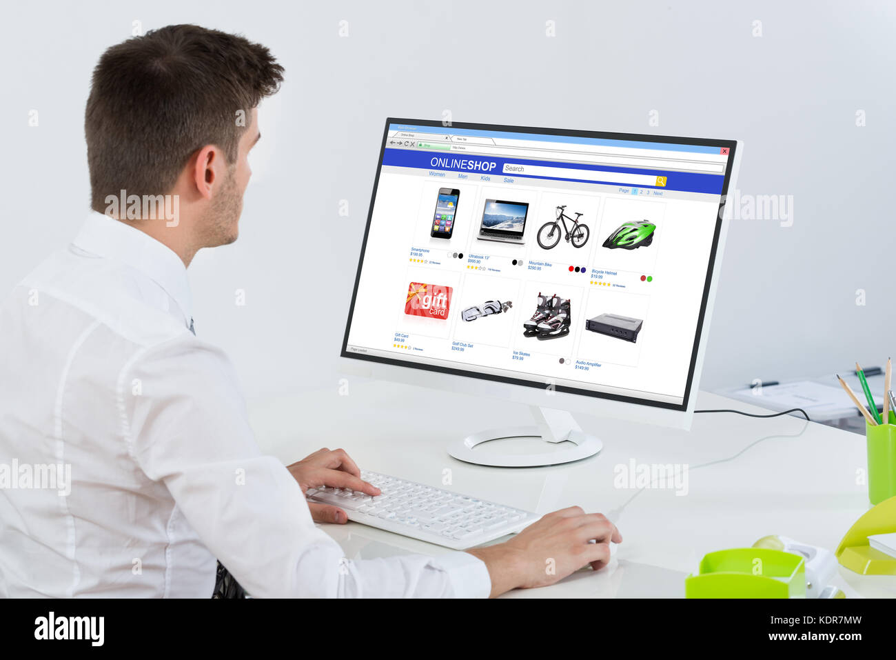 Male Employee Doing Online Shopping On Computer Desktop In Office Stock ...