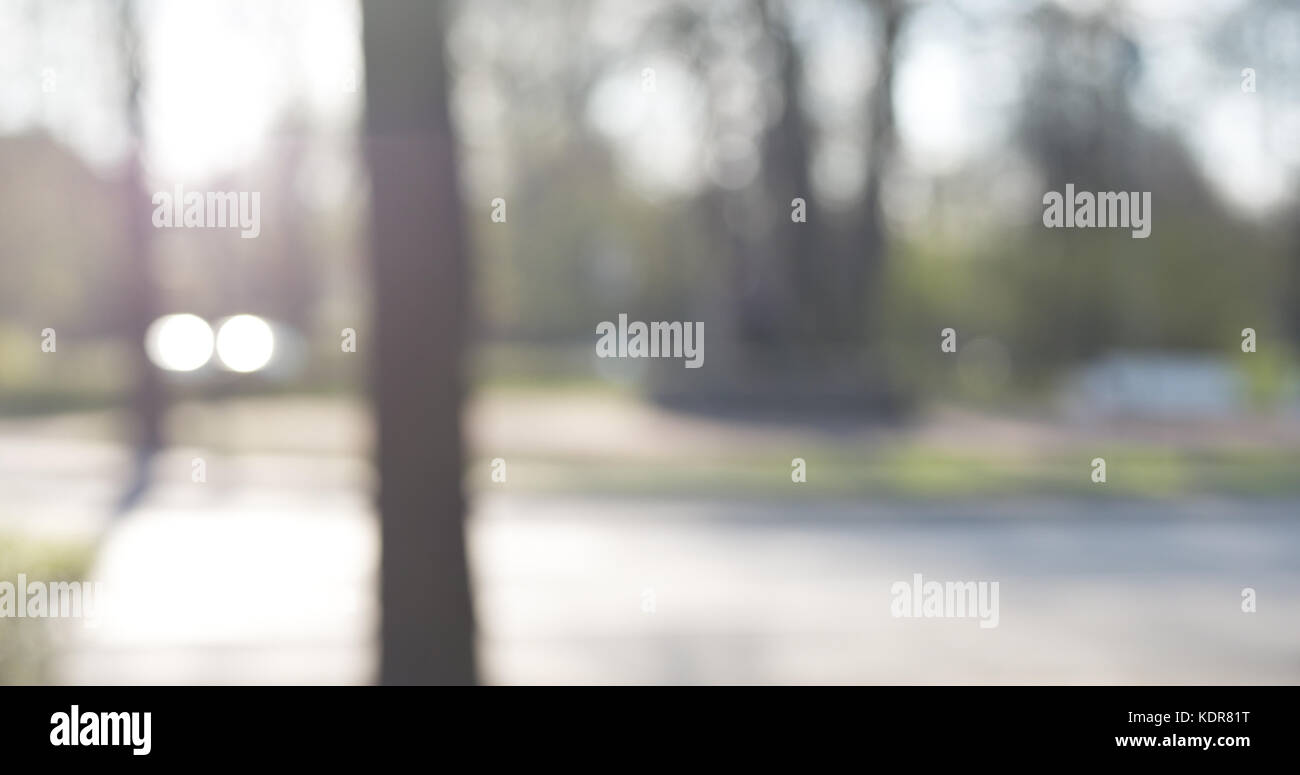 blurred background of traffic in green town at daytime Stock Photo - Alamy