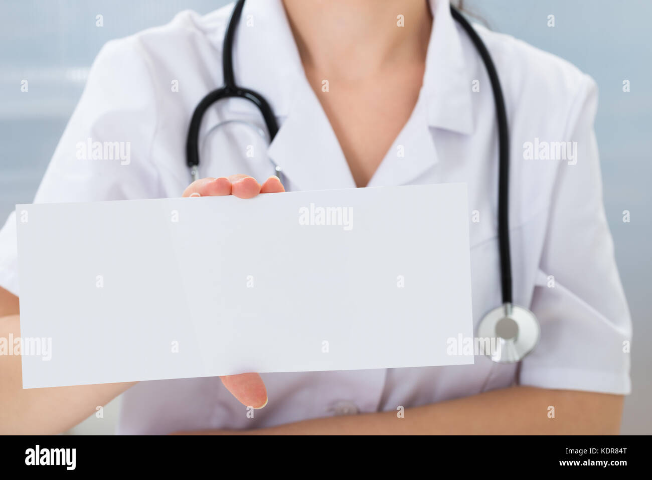 Close-up Of Doctor Holding Blank Paper In Clinic Stock Photo - Alamy