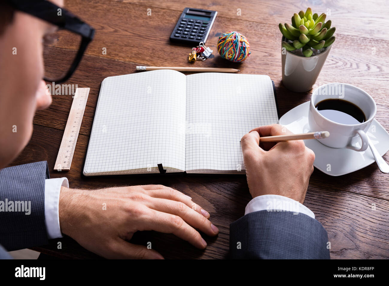 High Angle View Of Businessman Hand Writing On Blank Notebook With ...