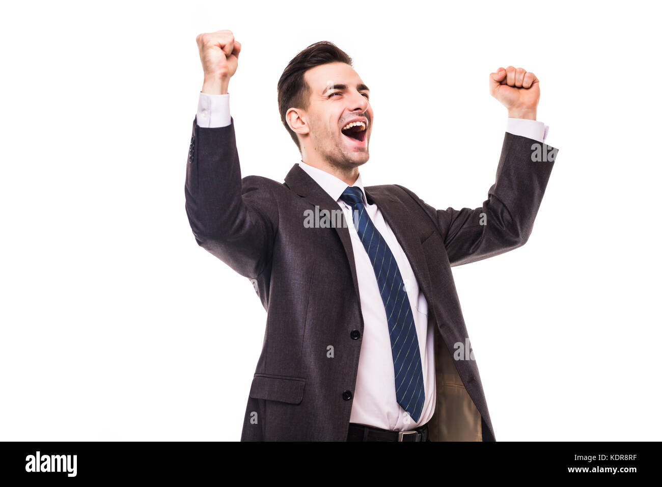 Happy young business man celebrating success shouting upwards, over ...