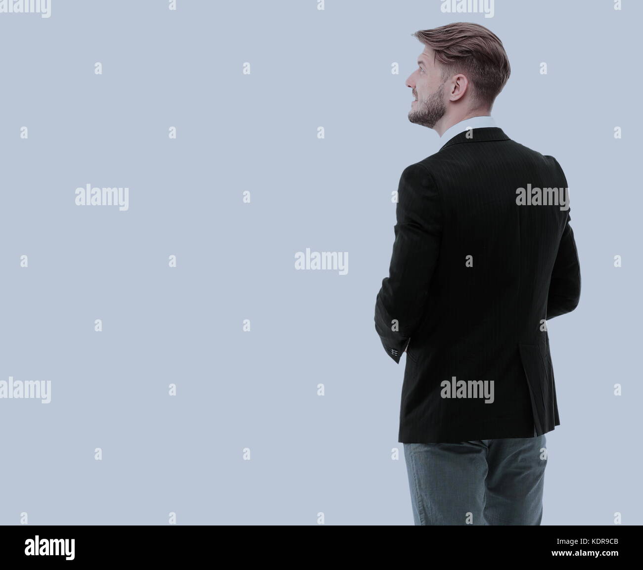 Businessman from the back - looking at something over a white ...