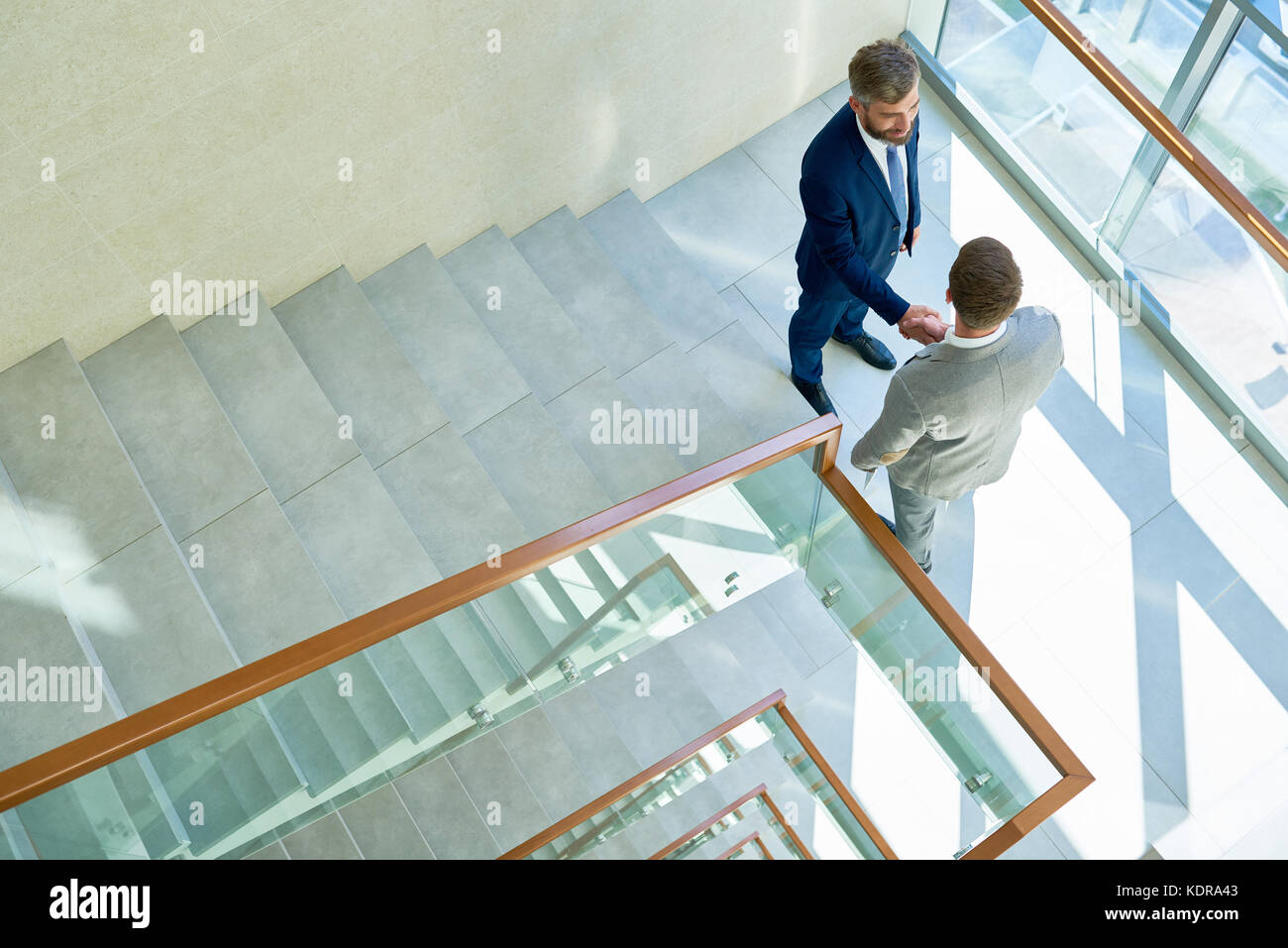 Greeting Colleague with Handshake Stock Photo - Alamy