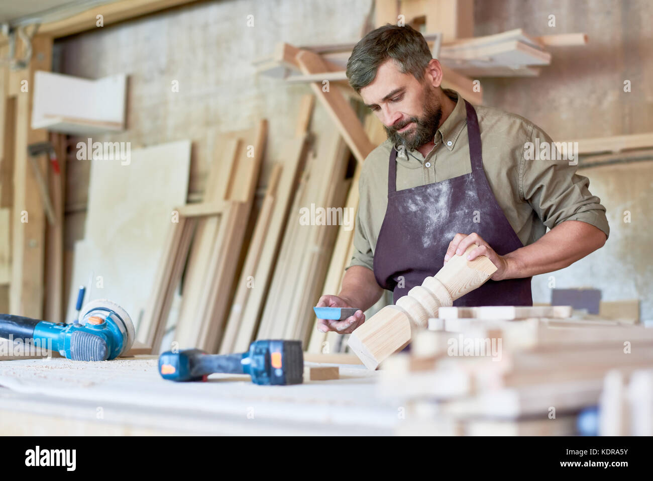 Bearded Carpenter Carving Stair Posts in Workshop Stock Photo - Alamy