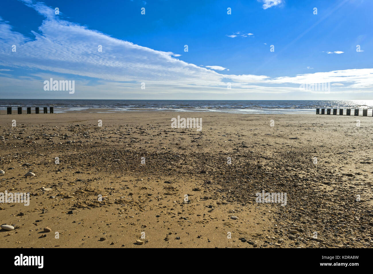 Empty beach under blue sky at seaside Stock Photo - Alamy