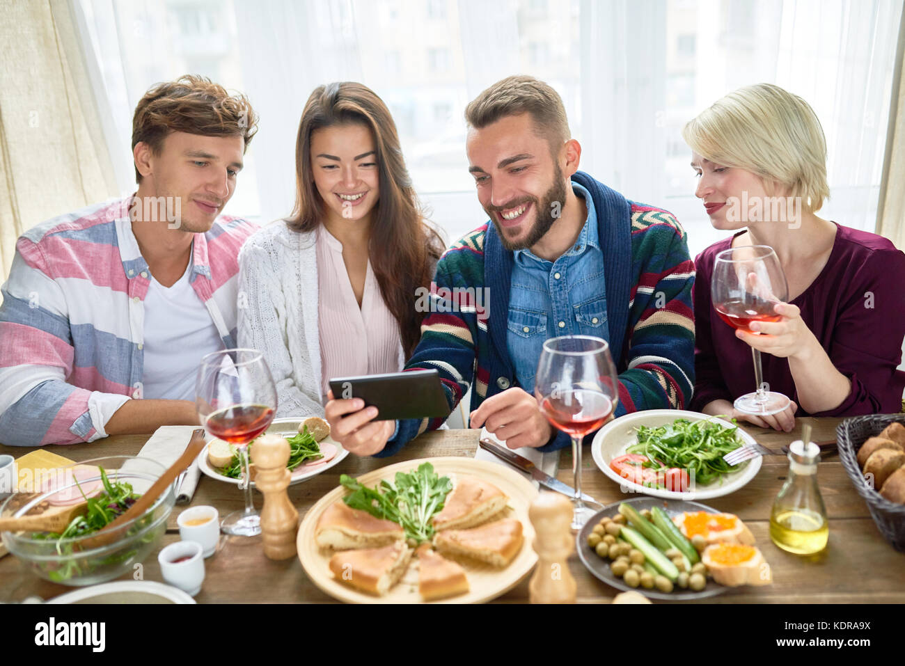 Happy friends watching screen hi-res stock photography and images - Alamy