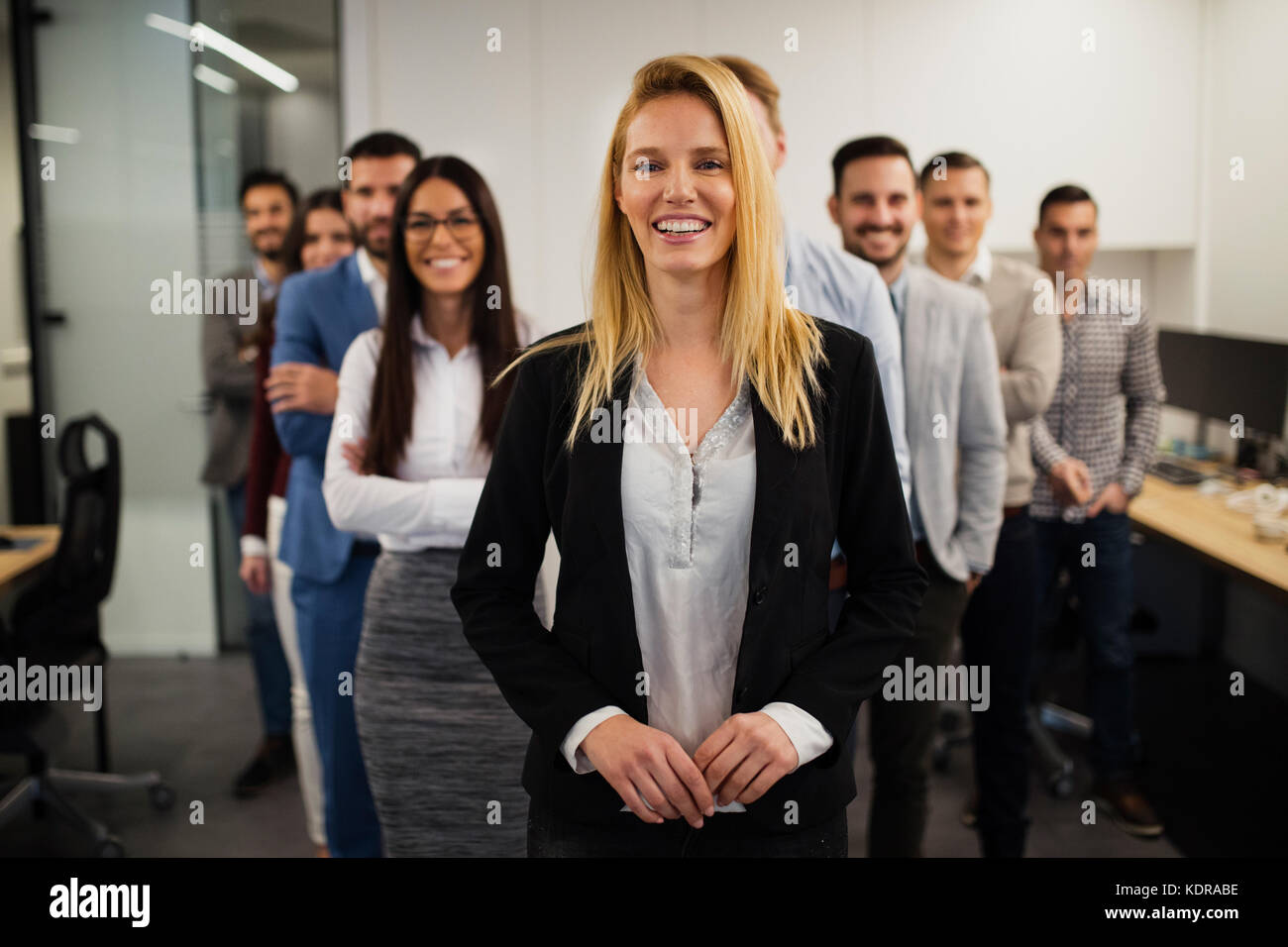 Business lady with positive look and cheerful smile posing for camera ...