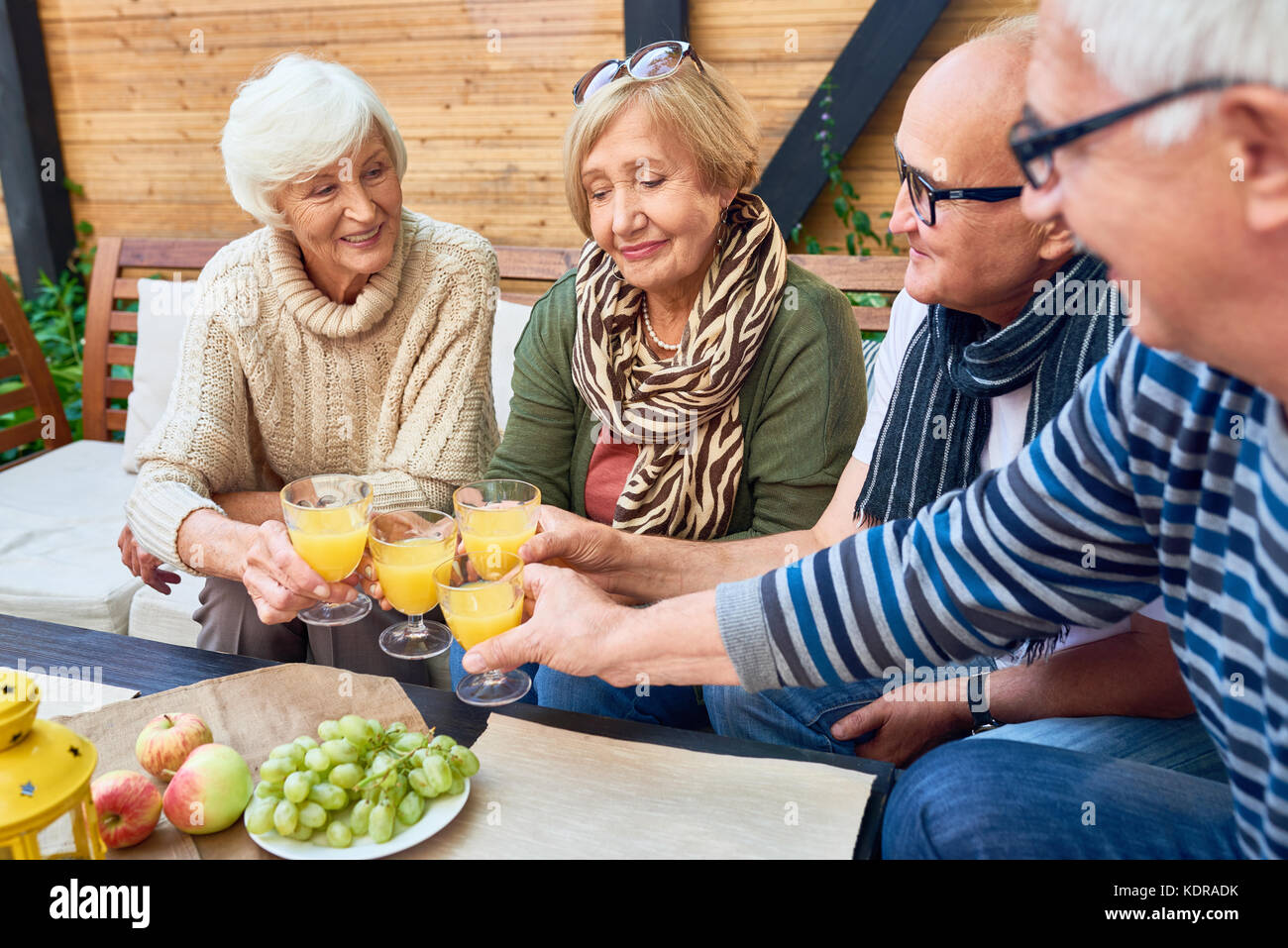 Group of Retired Friends Toasting at Lunch Stock Photo - Alamy