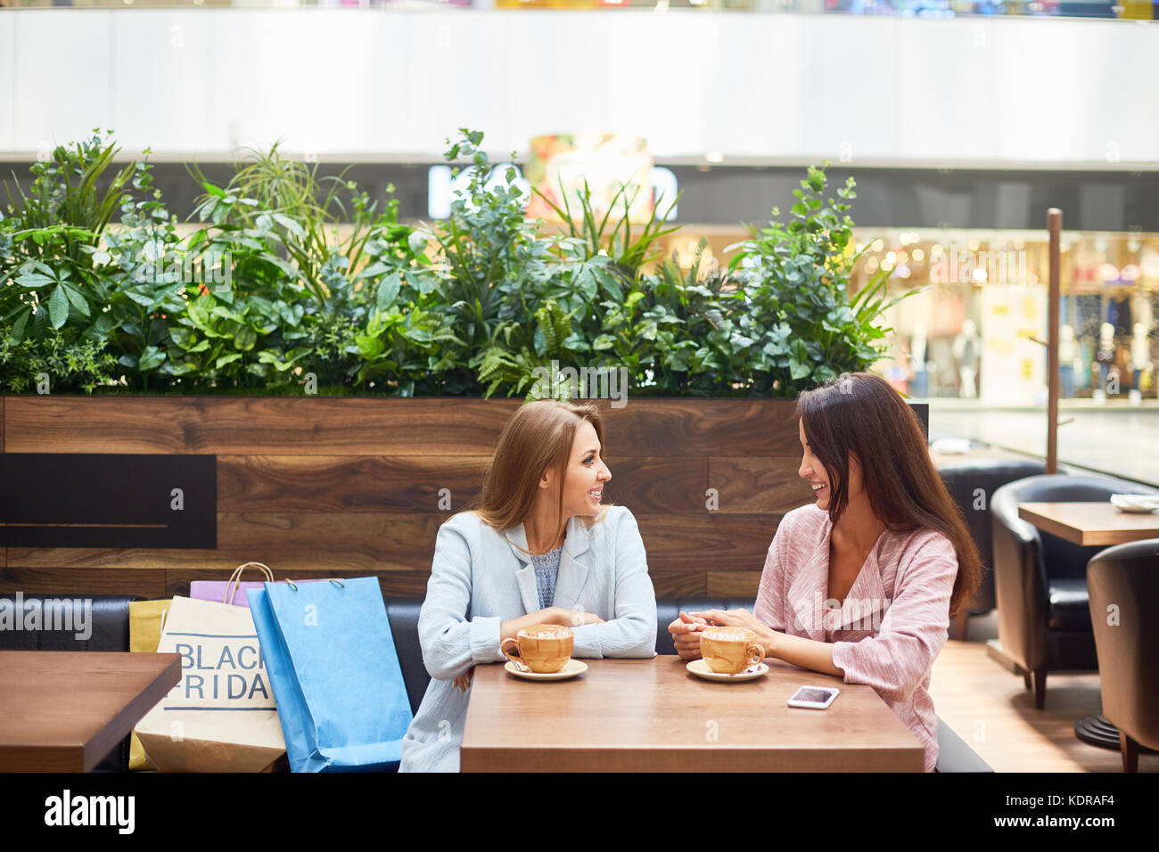 Young Women in Shopping Center Cafe Stock Photo - Alamy