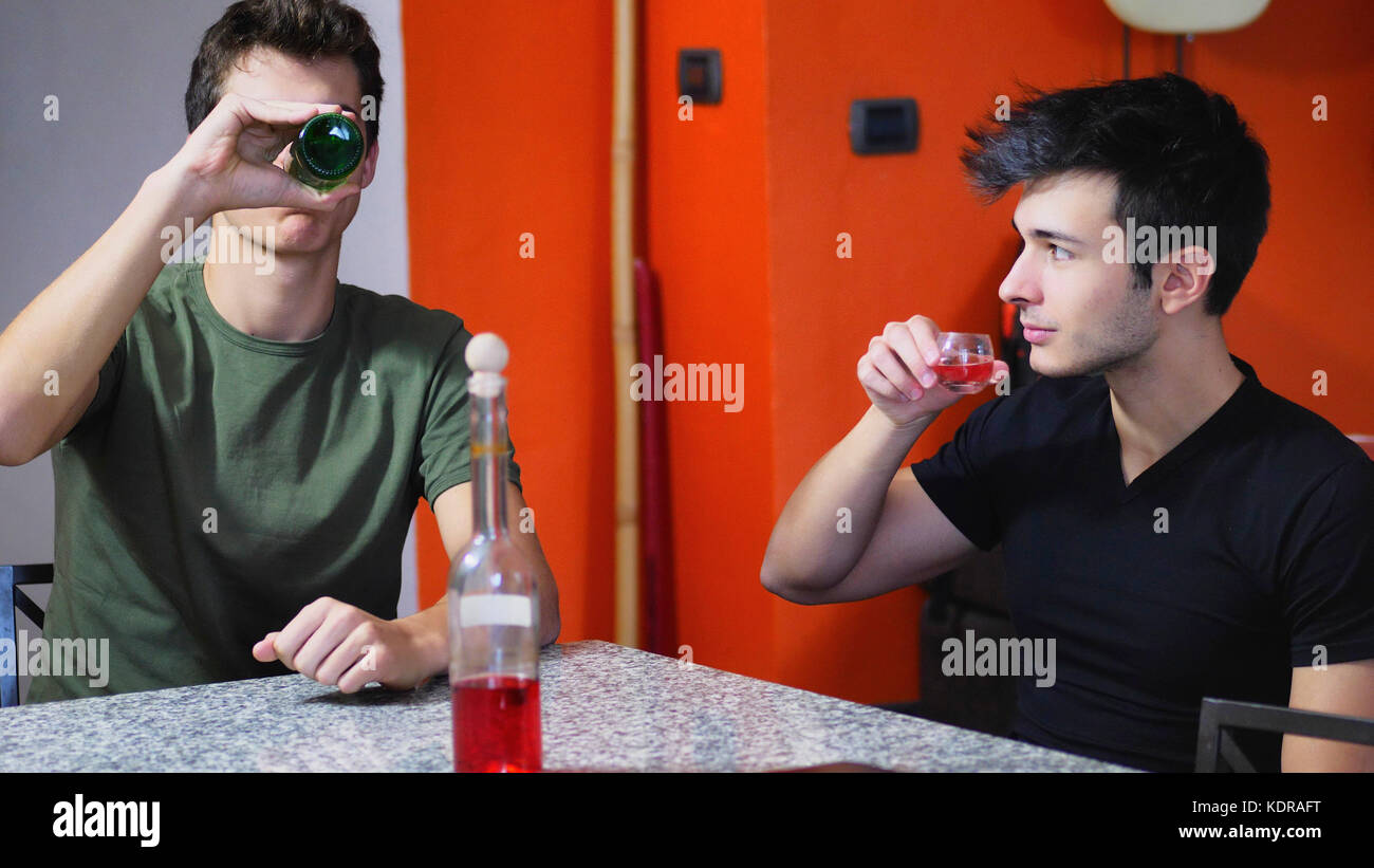 Content young men partying at table Stock Photo - Alamy