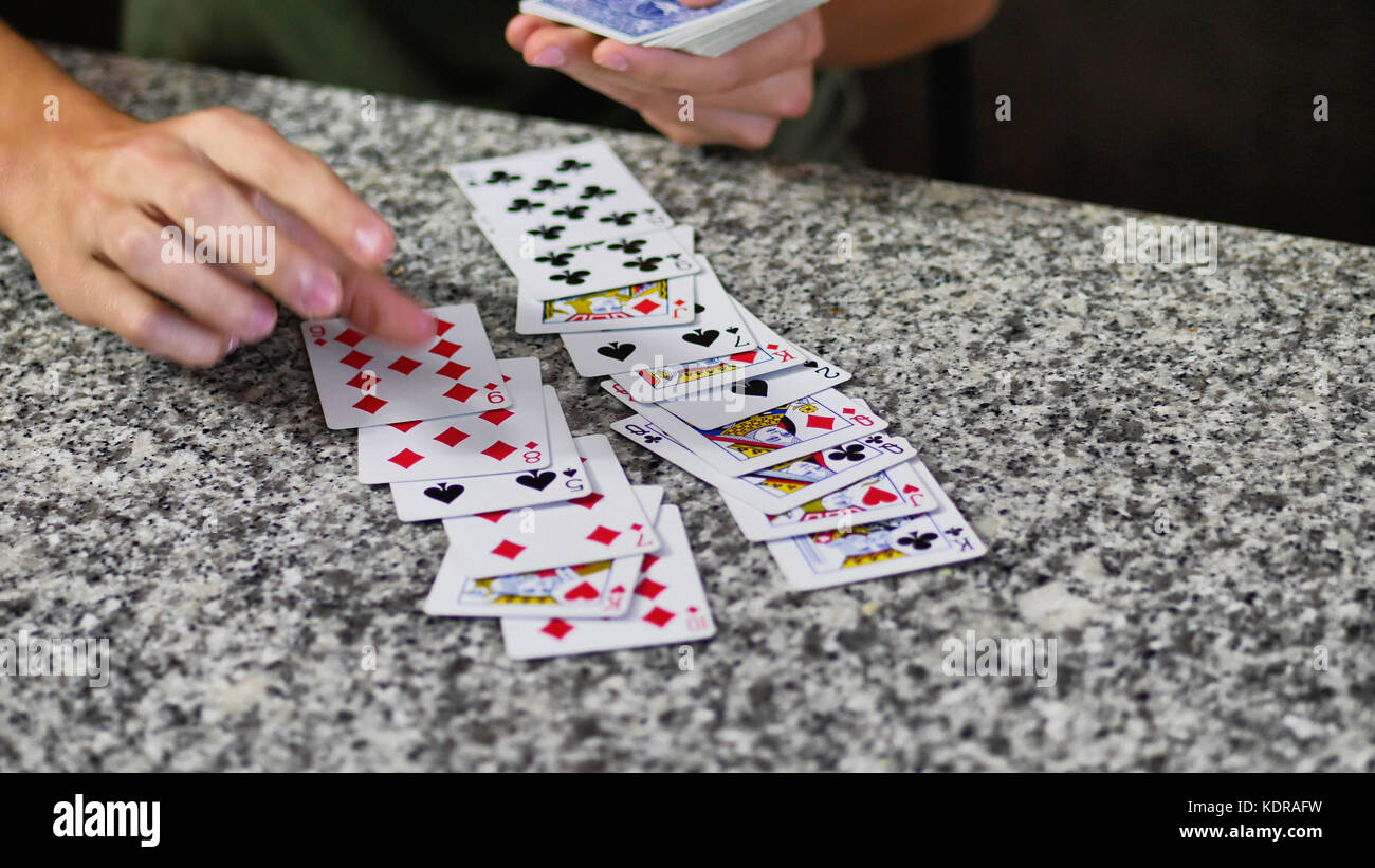Cheerful friends playing cards Stock Photo - Alamy