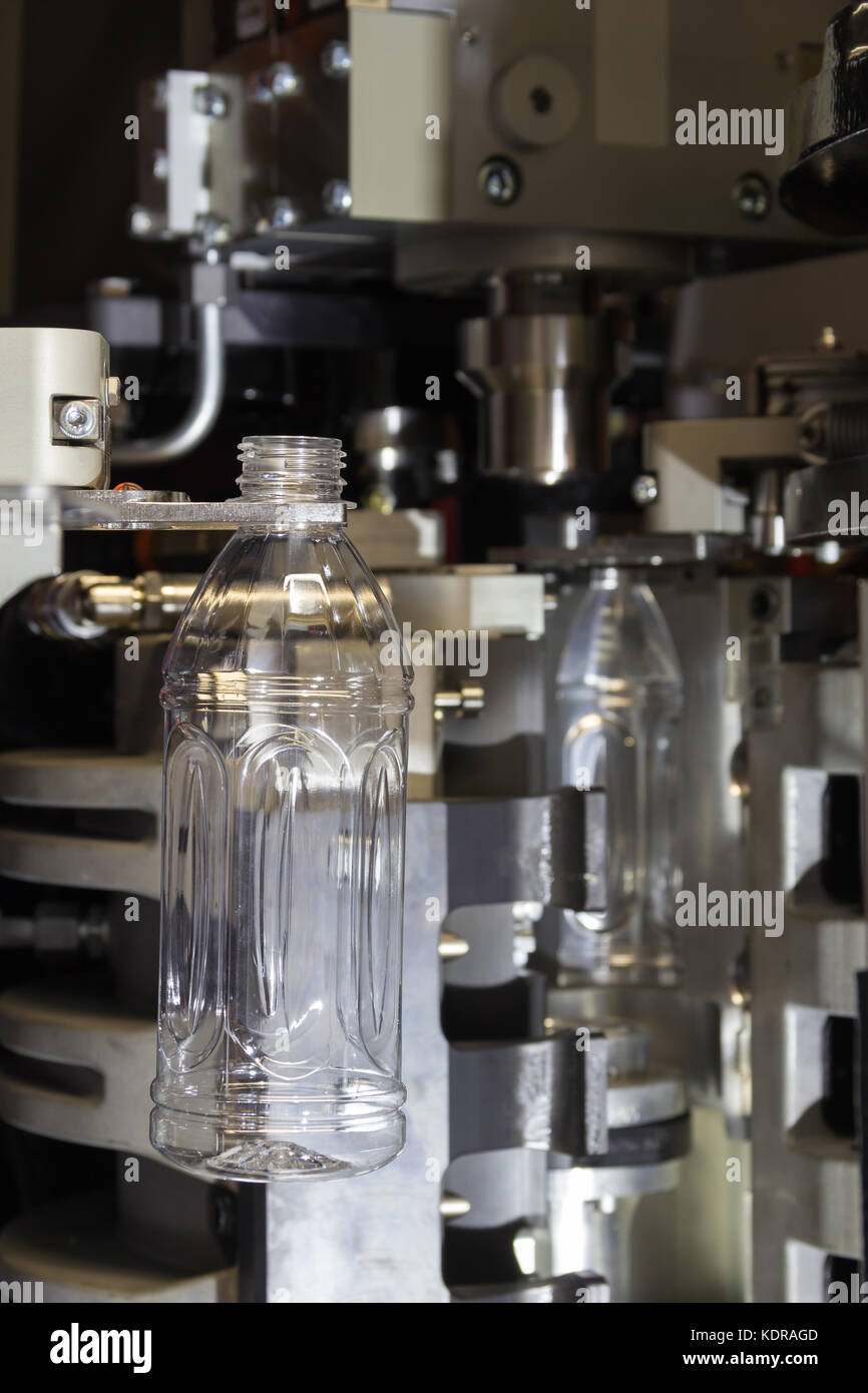 PET bottles blowing. The plastic bottle blowing machine.Heating process ...