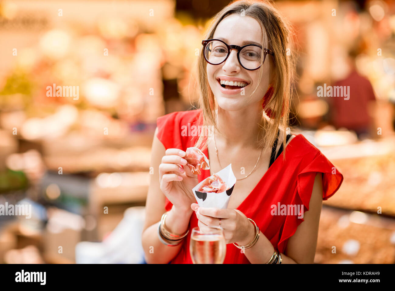 Spanish woman eating jamon at the market Stock Photo - Alamy