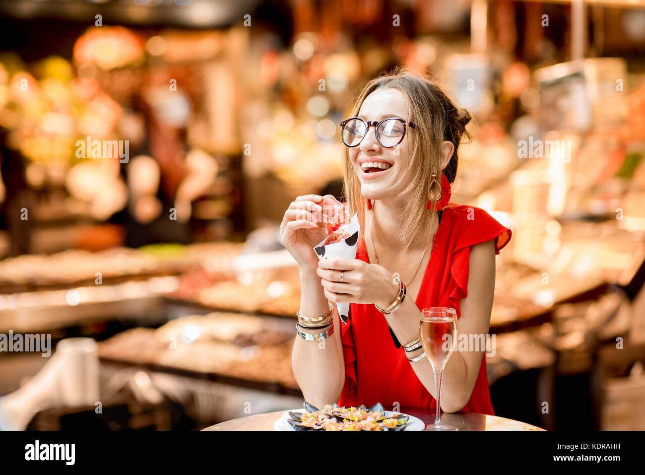 Spanish woman eating jamon at the market Stock Photo - Alamy