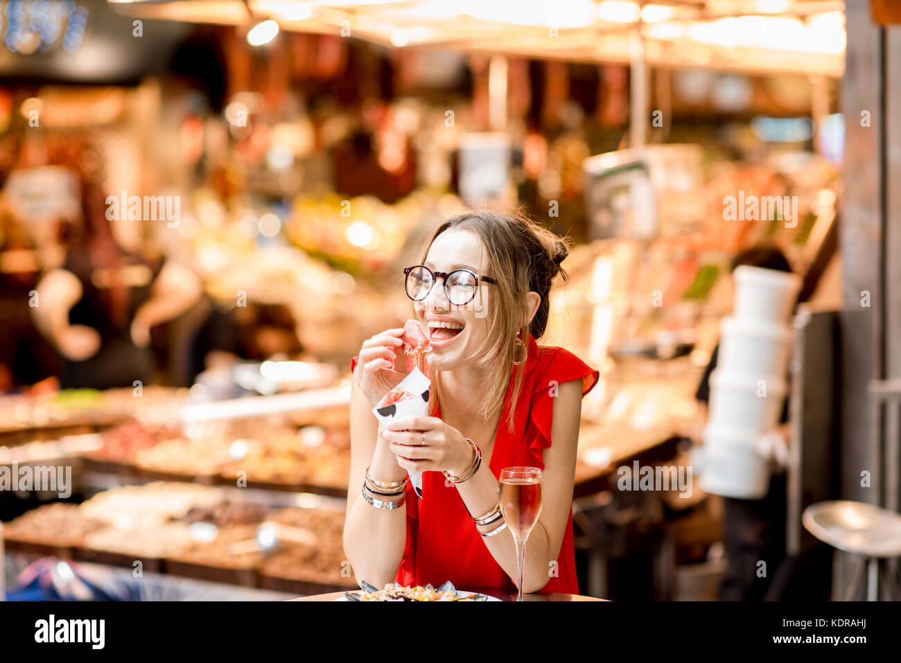 Spanish woman eating jamon at the market Stock Photo - Alamy