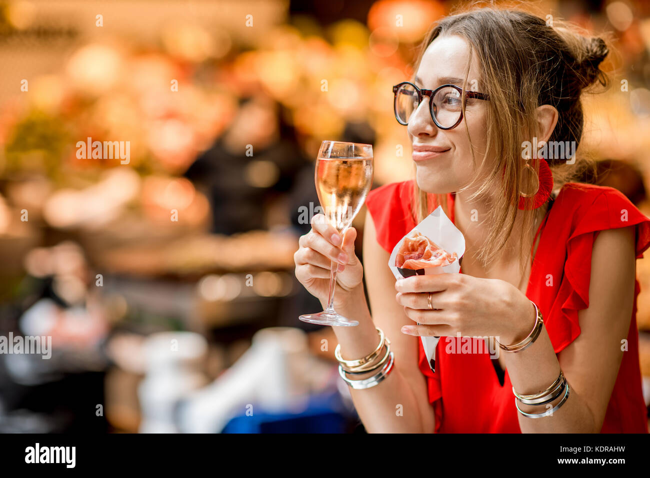 Spanish woman eating jamon at the market Stock Photo - Alamy