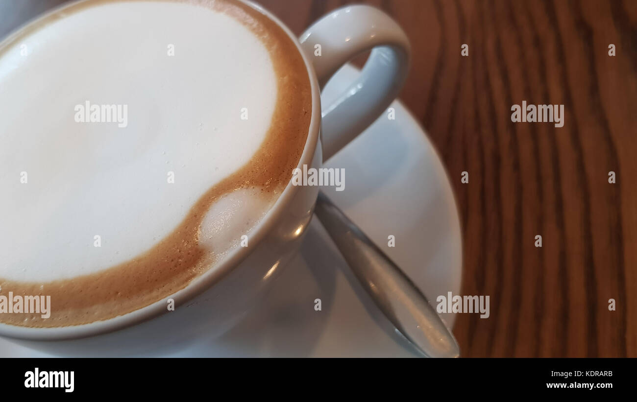 Hot coffee latte with milk cream on top Stock Photo - Alamy