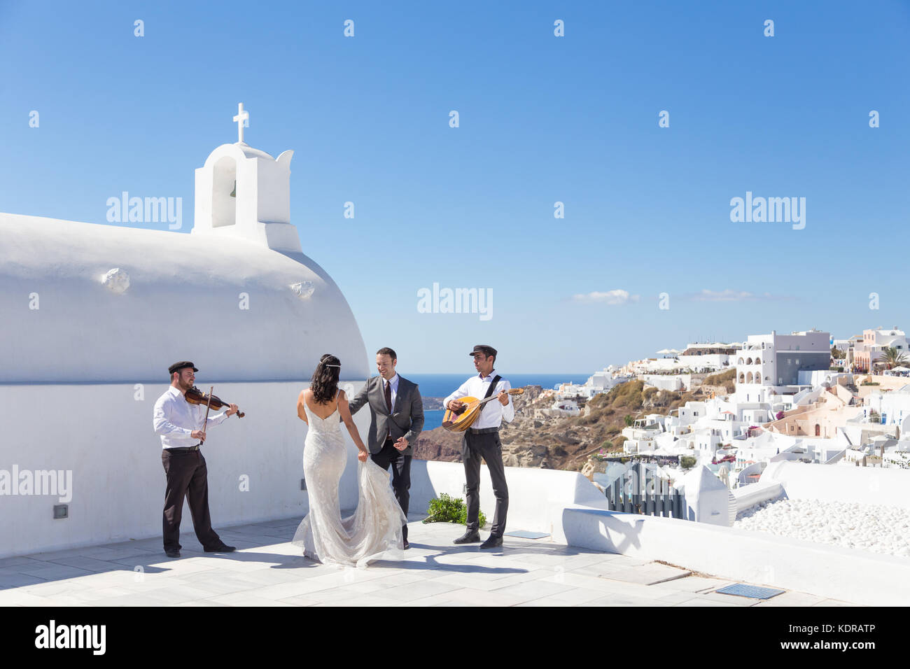 Bride and groom dansing on wedding ceremony on Santorini island, Greece ...