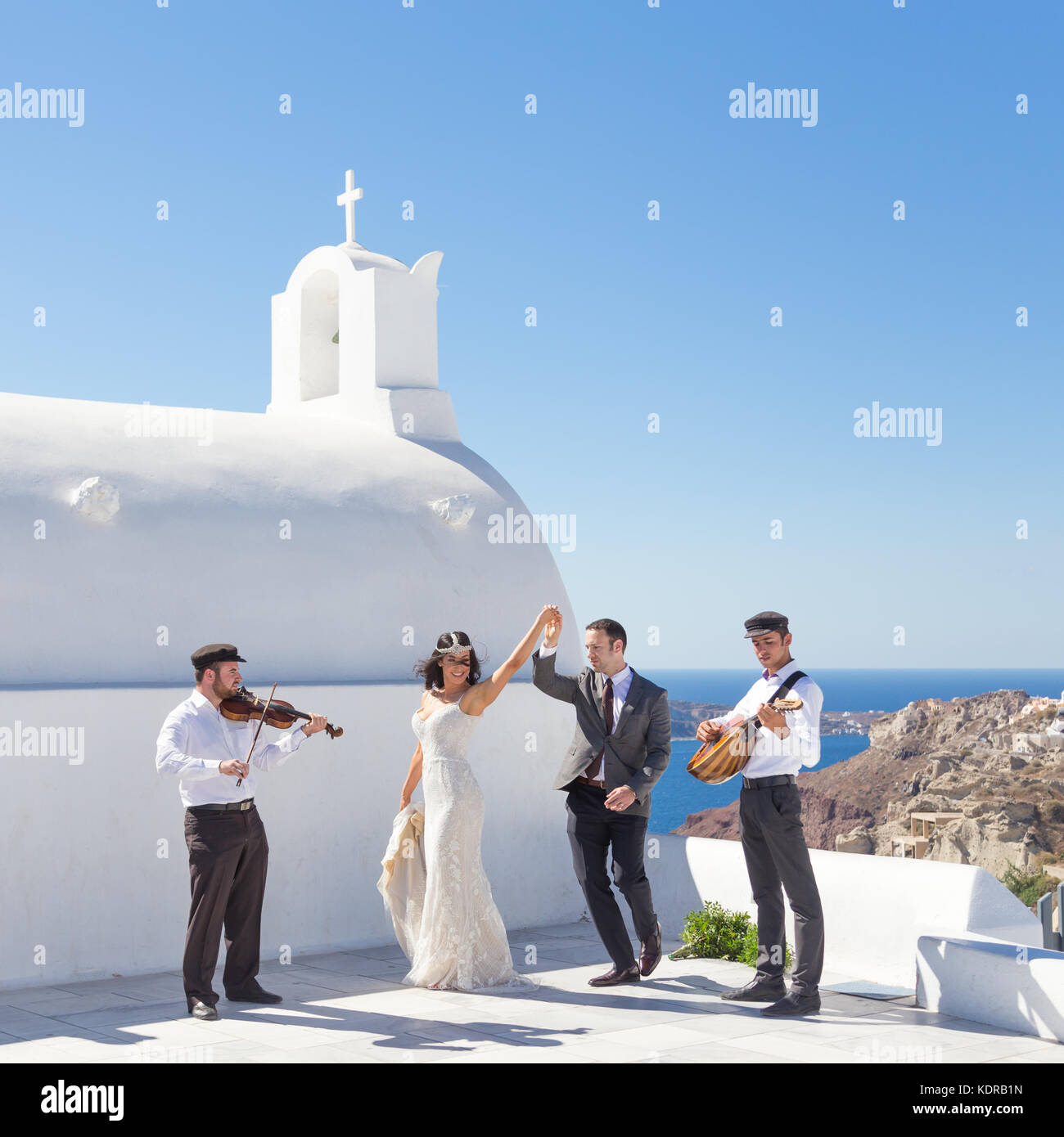 Bride and groom dansing on wedding ceremony on Santorini island, Greece ...