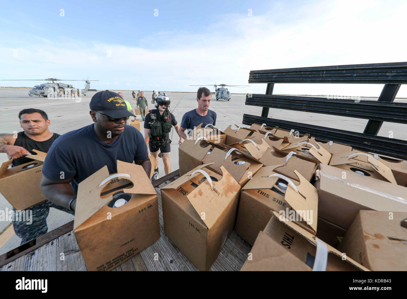 U.S. Navy sailors load emergency supplies on to a truck at the Naval ...