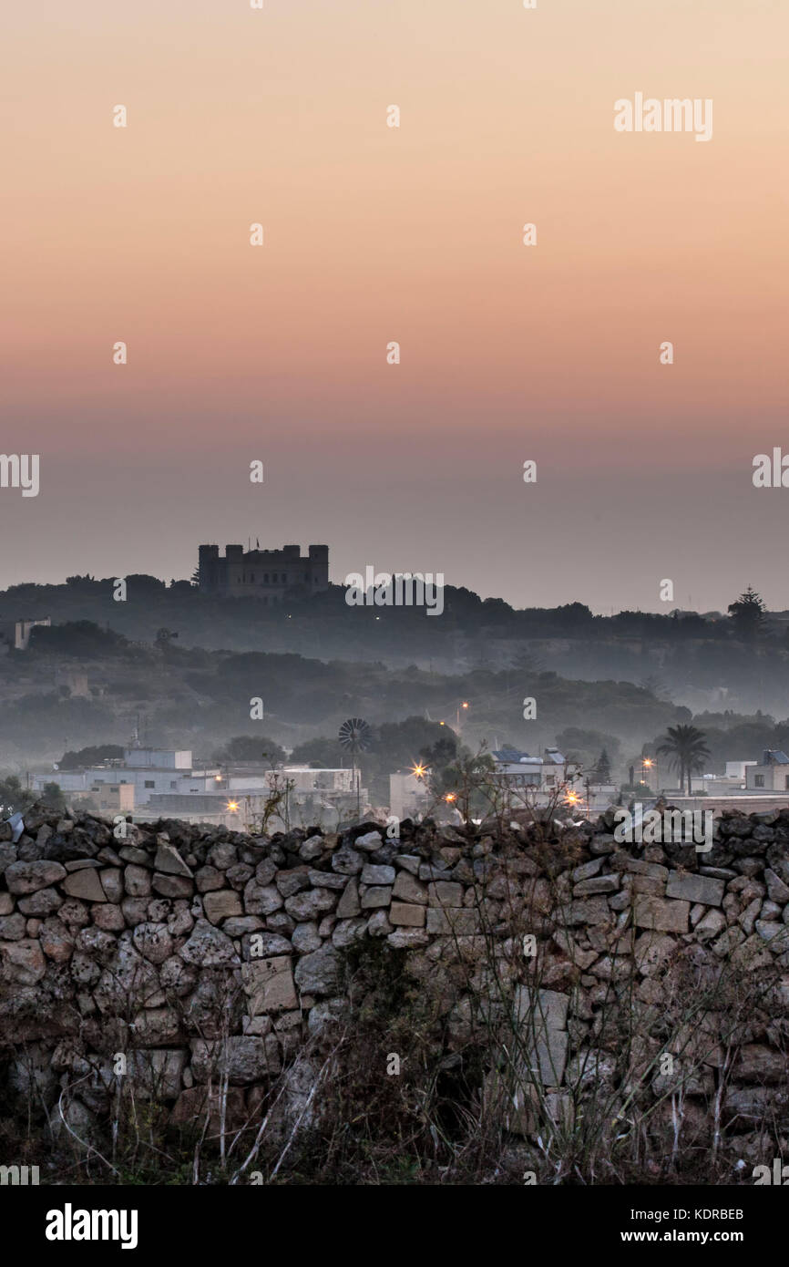 Verdala Palace in Malta rises above the misty countryside at dawn Stock ...