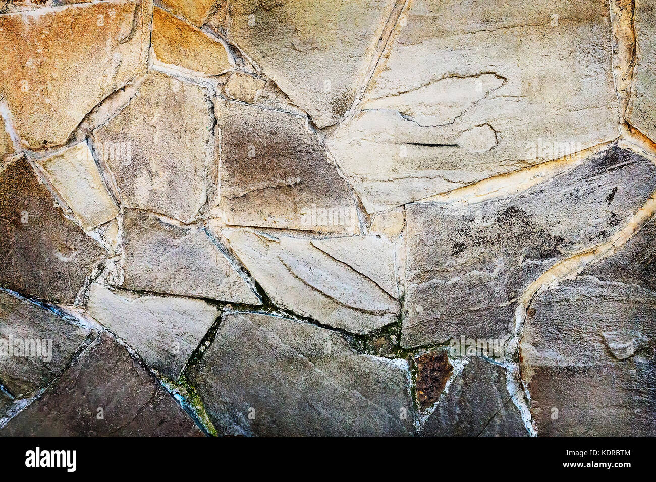 Fragment of the ancient stone wall executed from stones of various form ...