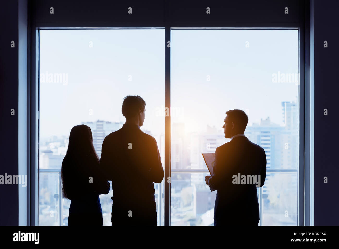 Couple and real estate agent window deal concept Stock Photo - Alamy