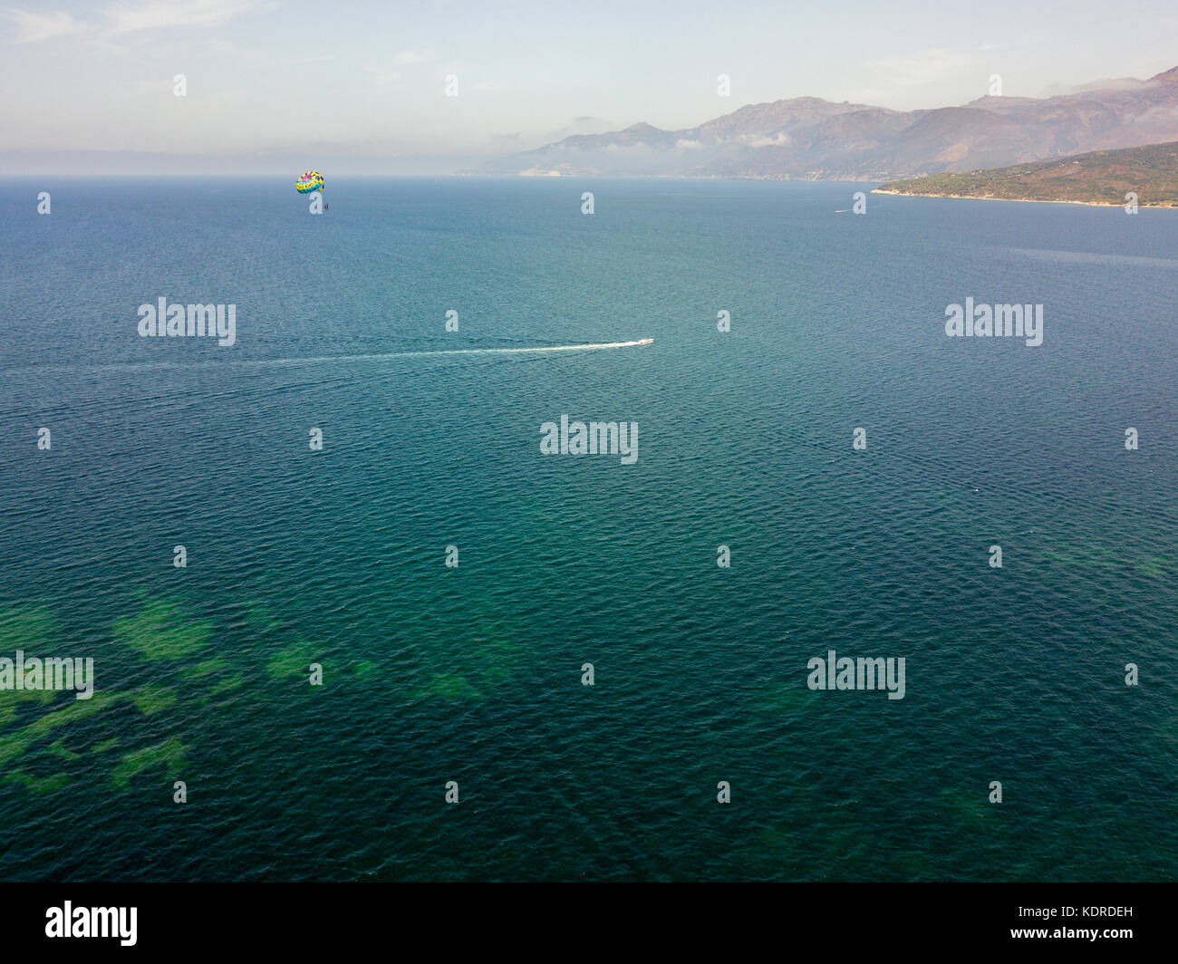 Aerial view of people practicing parasaling, parachutes dragged by a ...