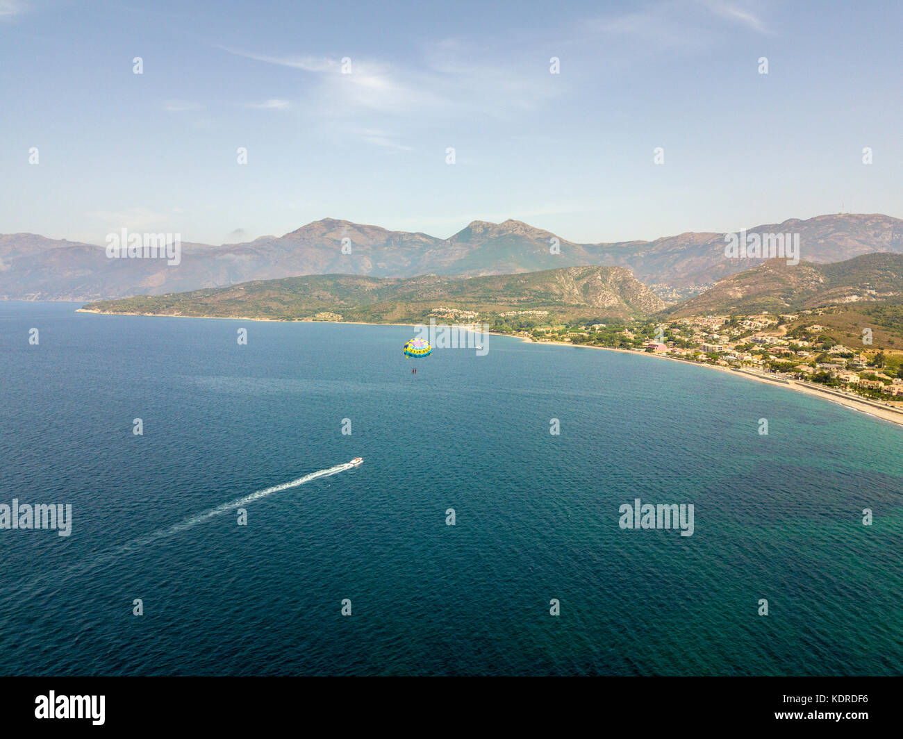 Aerial view of people practicing parasaling, parachutes dragged by a ...