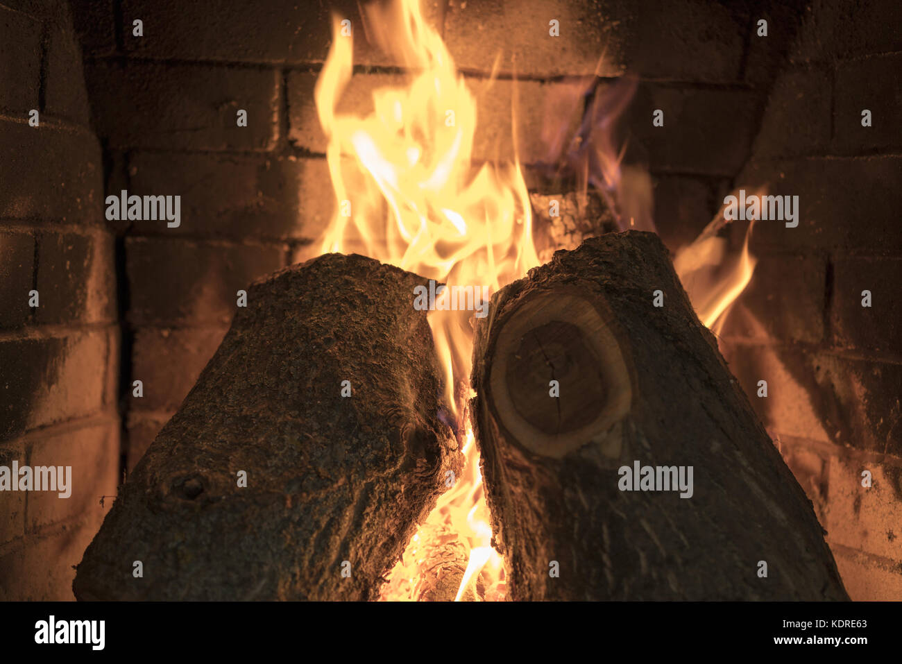 Large firewood burn in the fireplace Stock Photo - Alamy