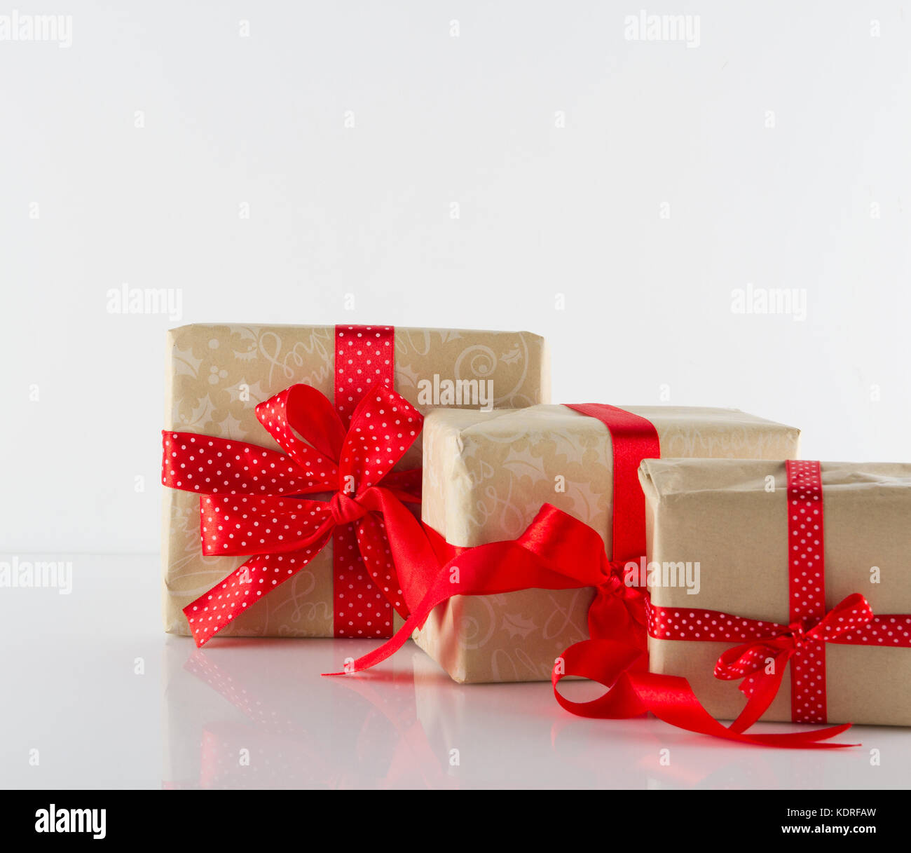 Three gifts boxes with ribbons on white Stock Photo - Alamy