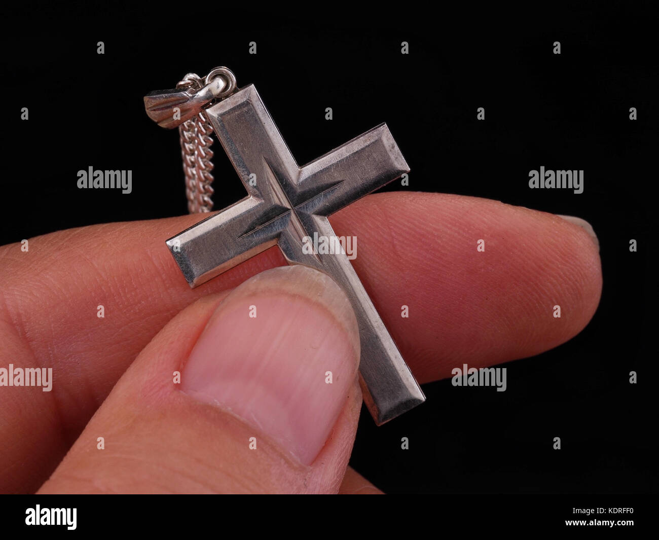 Woman holding chain cross hi-res stock photography and images - Alamy
