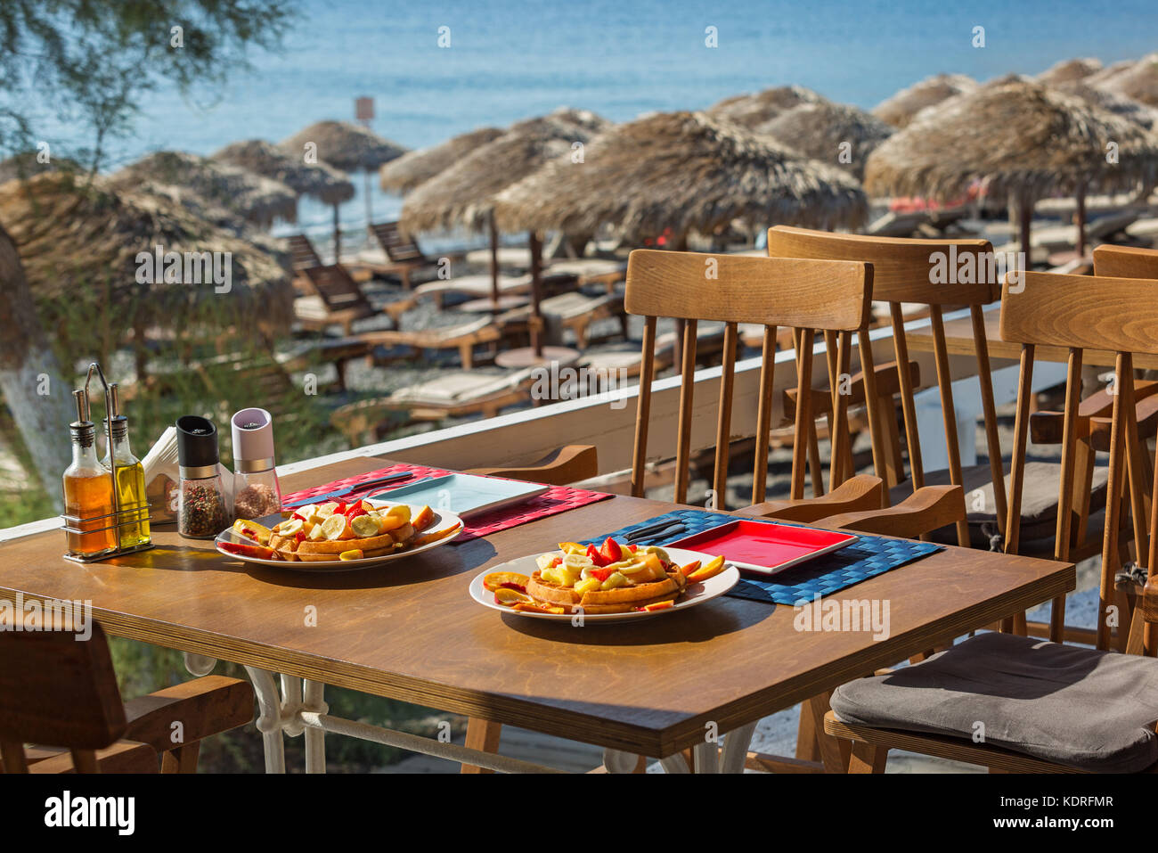 Two plates with the dessert on the table at beach cafe Stock Photo - Alamy