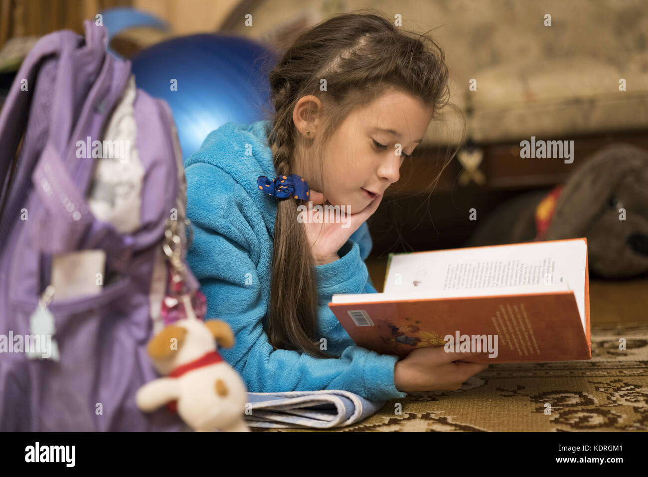 Child reading book at home. Girl doing homework Stock Photo - Alamy