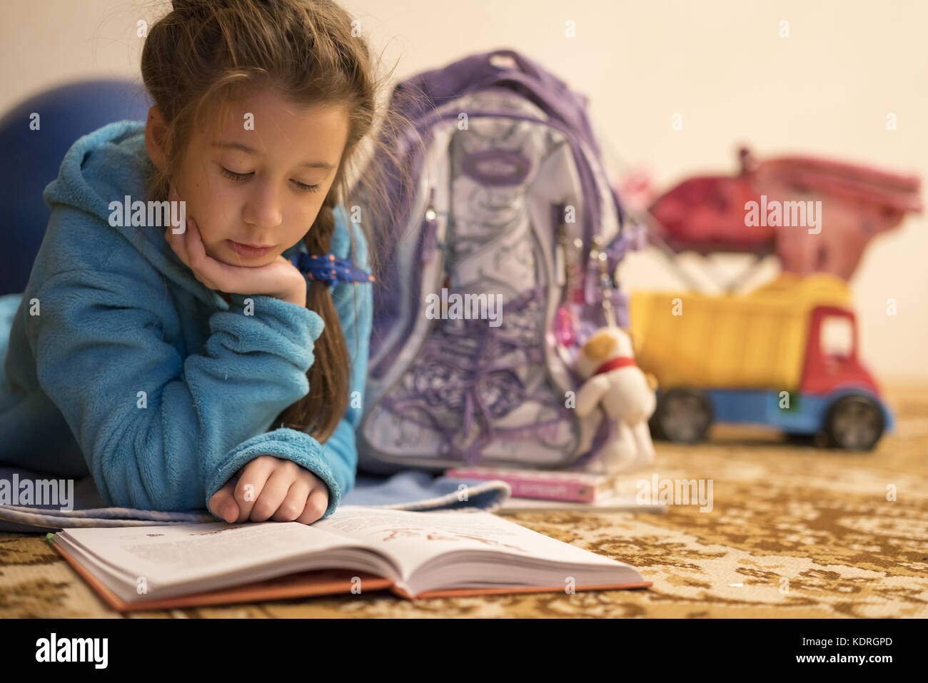 Schoolgirl reading homework Stock Photo - Alamy