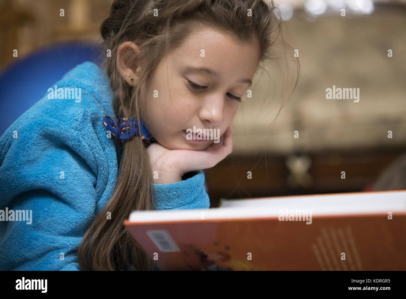 Child girl reading her favorite story Stock Photo - Alamy