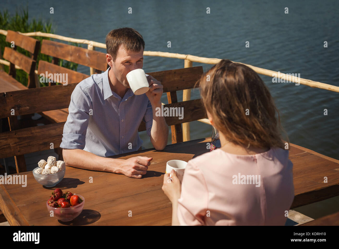 pretty couple drinking tea outdoors Stock Photo - Alamy