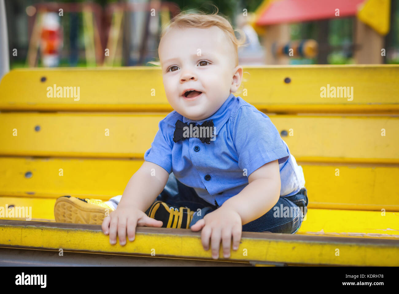handsome boy sitting on bench Stock Photo - Alamy