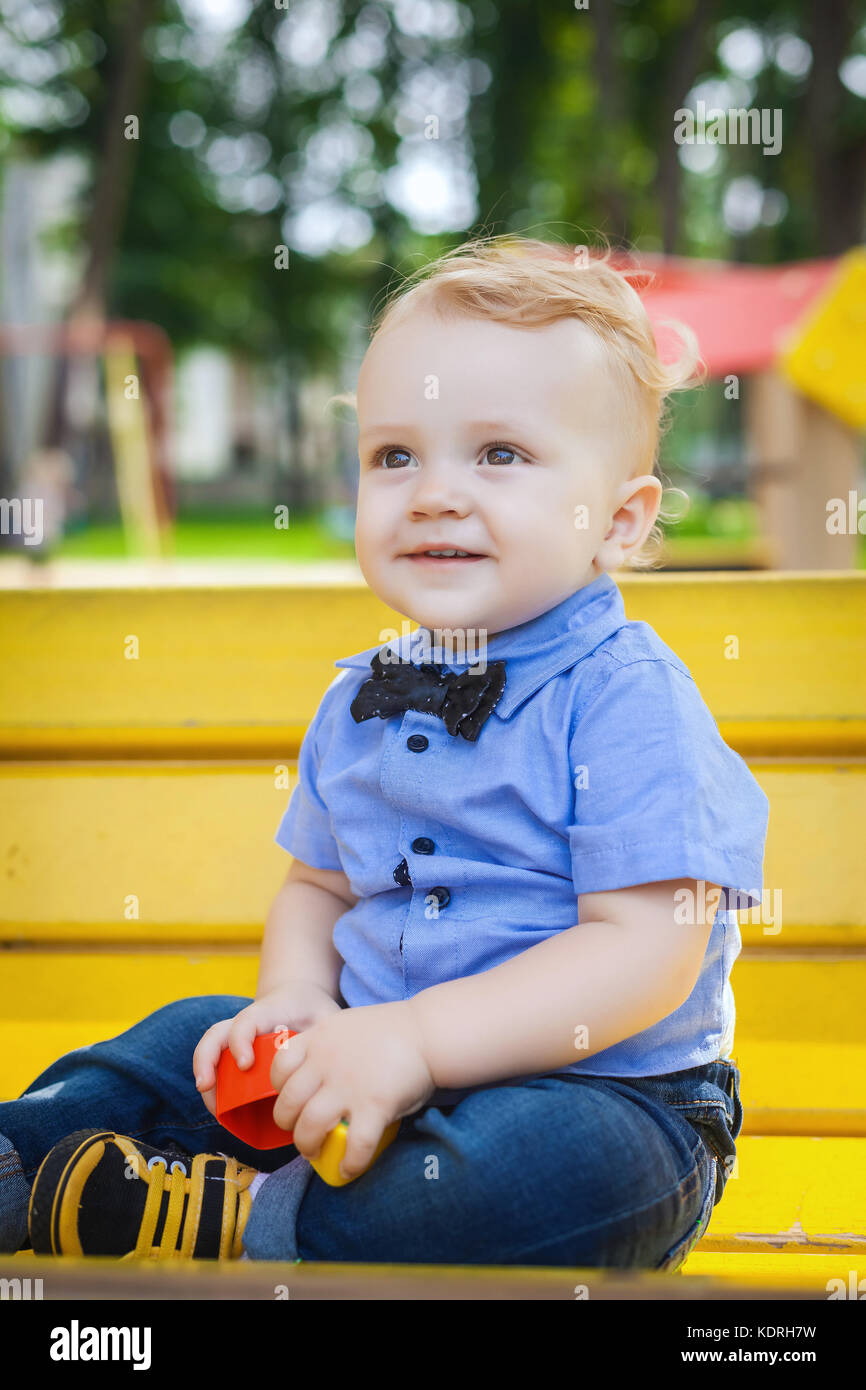 cute boy sitting on bench Stock Photo - Alamy