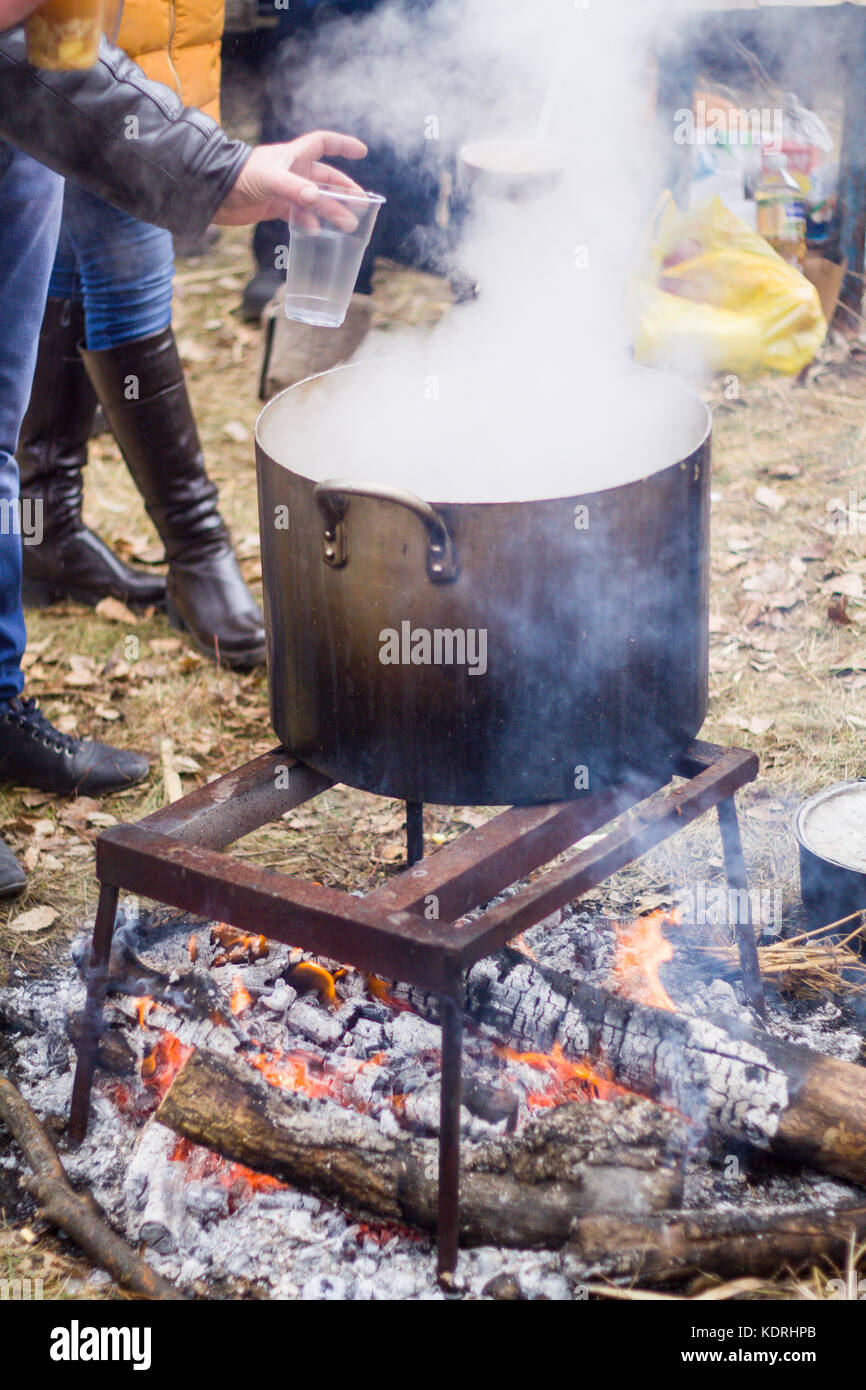 Cooking in the nature. Cauldron on fire in forest Stock Photo - Alamy