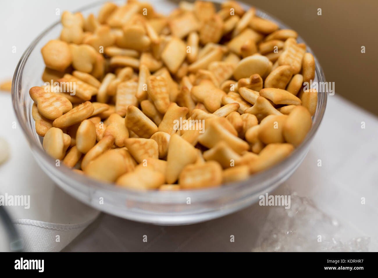 Bowl of mini cheddar cheese biscuits in a bowl on a white table top ...